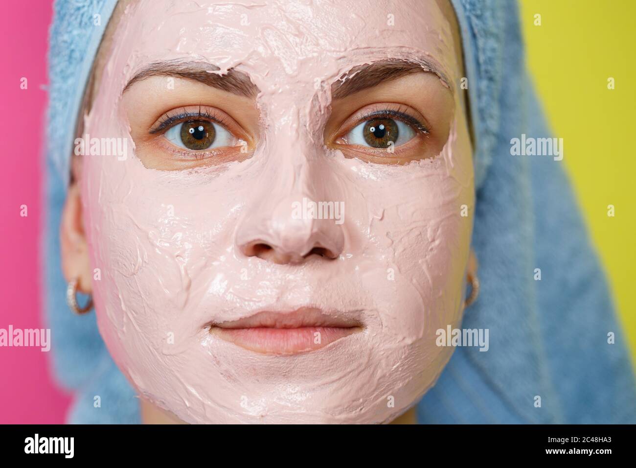 Portrait of a beautiful young girl who puts a refreshing mask on her ...