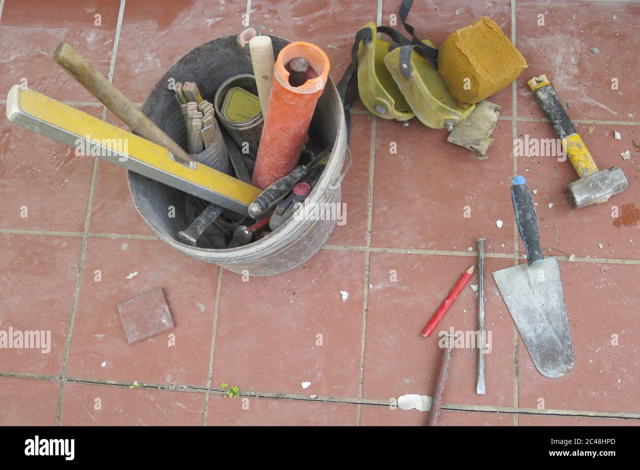 High angle shot of dirty ceramic tiles with some instruments Stock ...