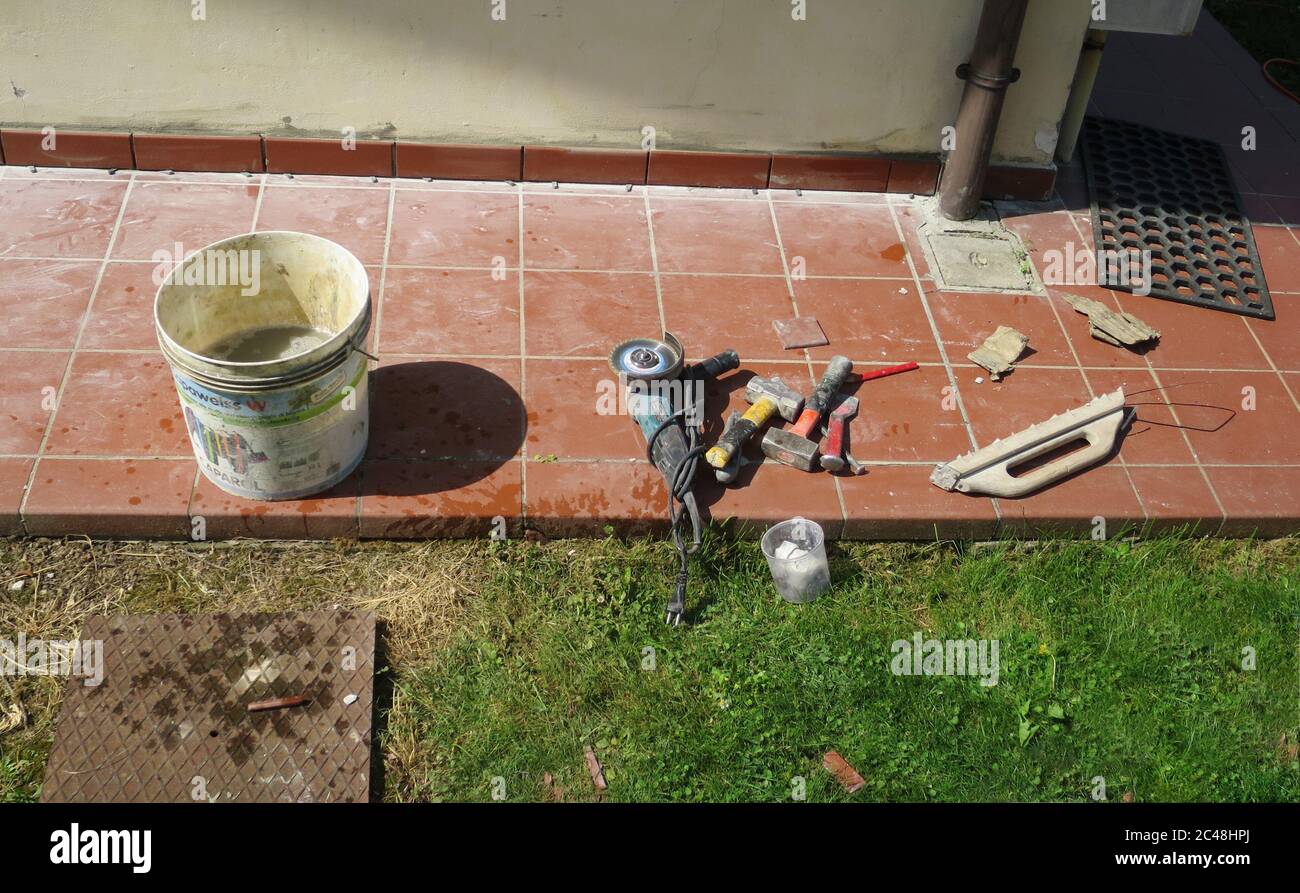 High angle shot of dirty ceramic tiles with some instruments Stock ...