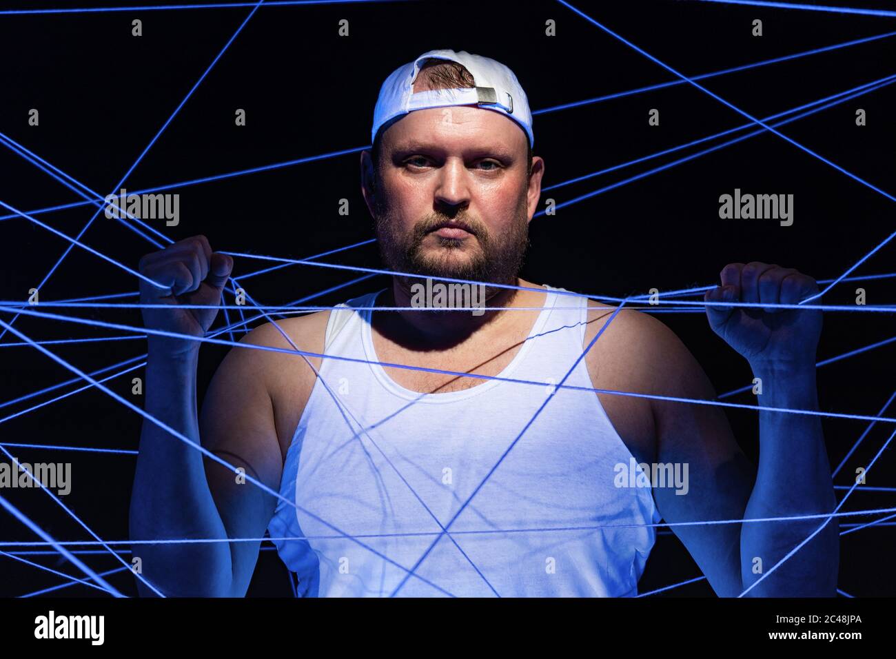 Portrait of stout man with white threads in neon light Stock Photo - Alamy