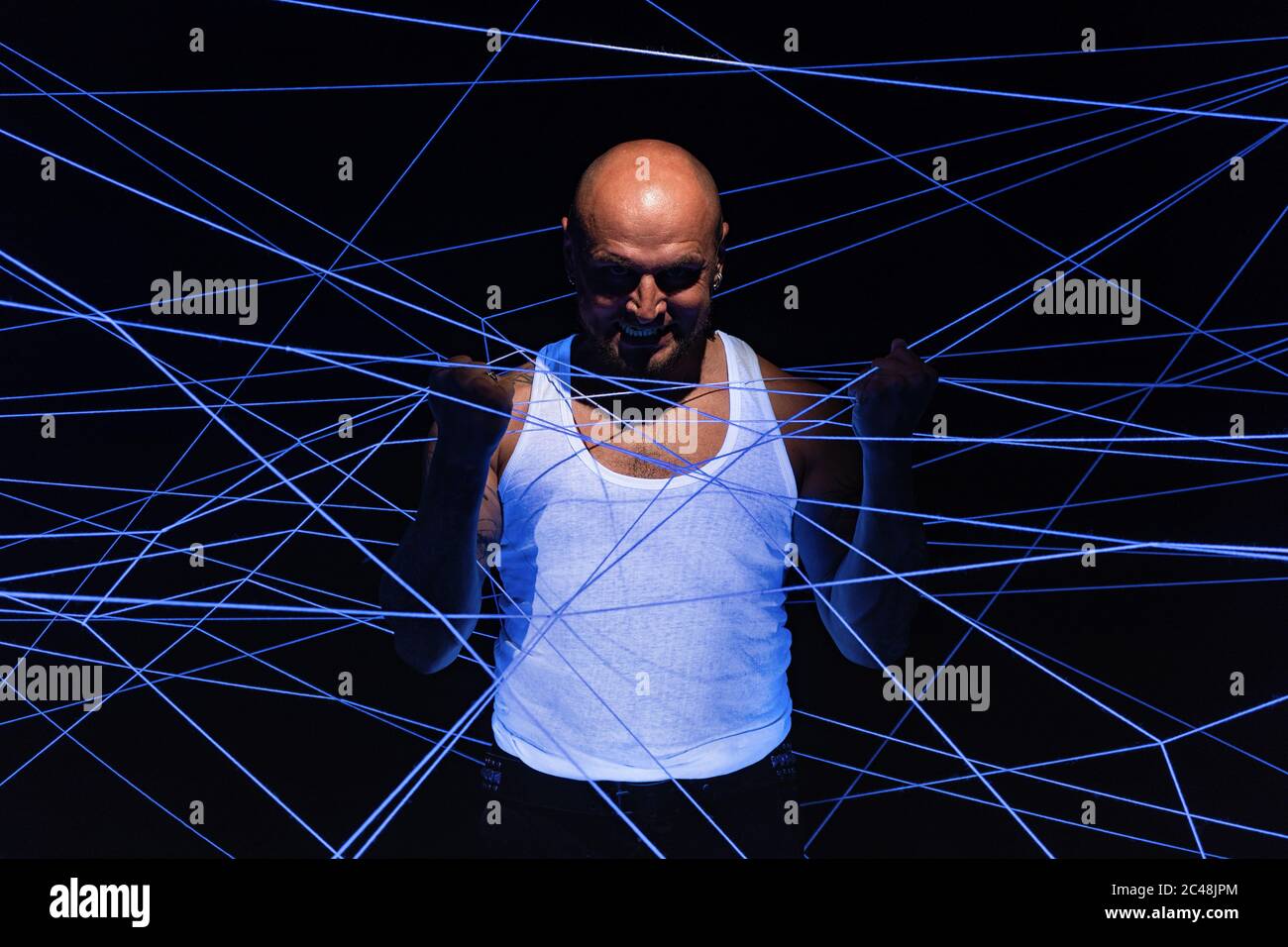 Photo of bald mad man tangled in white threads in ultraviolet Stock ...