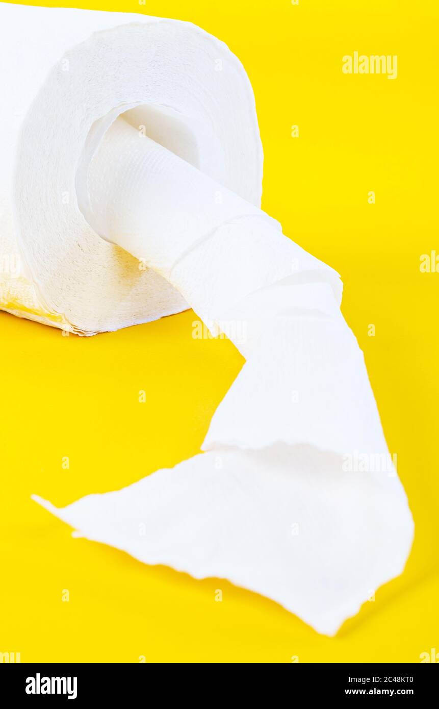 Tissue paper rolls on the yellow background Stock Photo - Alamy
