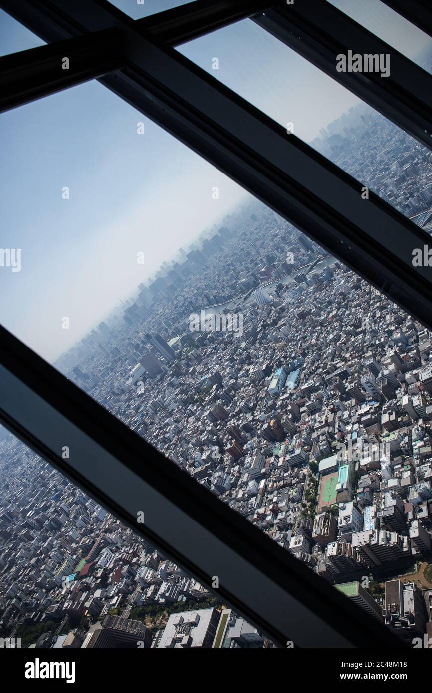 Vertical birds-eye view of a city from the skyscraper glass window ...
