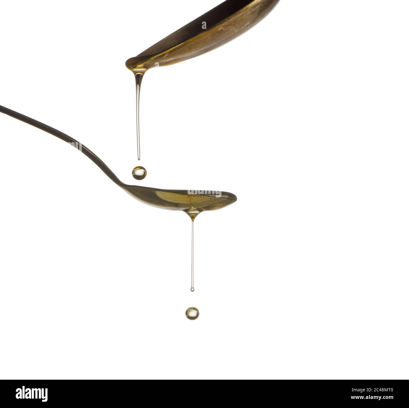 Pouring oil splash. Isolated on white background Stock Photo - Alamy