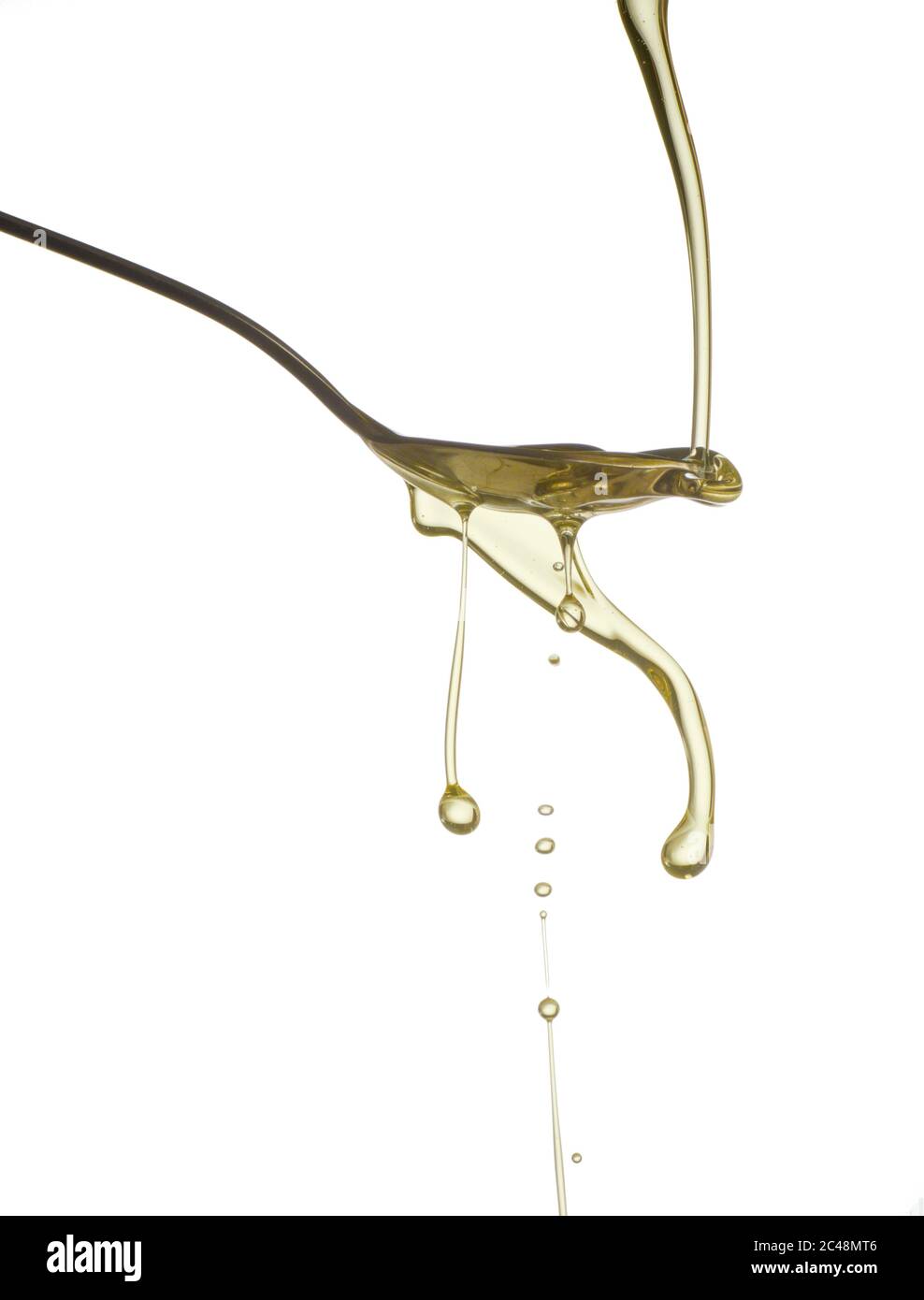 Pouring oil splash. Isolated on white background Stock Photo - Alamy