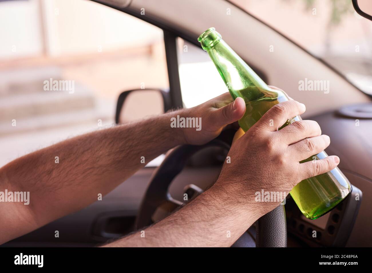 Hand holding beer bottle driving hi-res stock photography and images ...