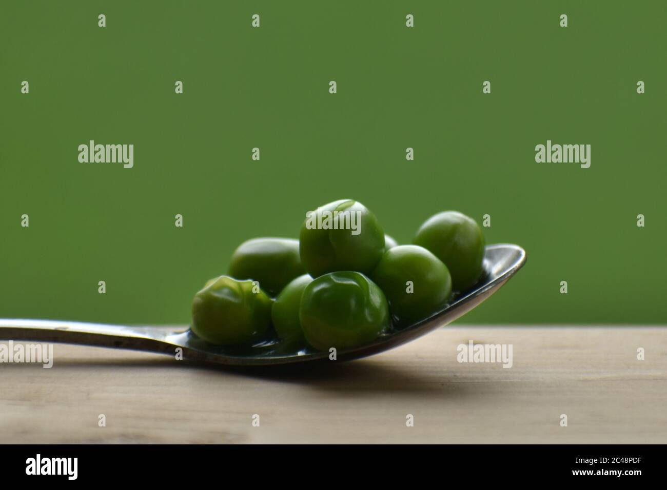 Closeup photograph of boiled Peas in a spoon Stock Photo - Alamy