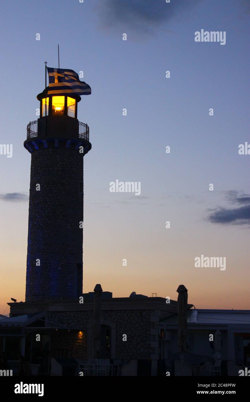 The lighthouse of Patras, with a Greek flag Stock Photo - Alamy