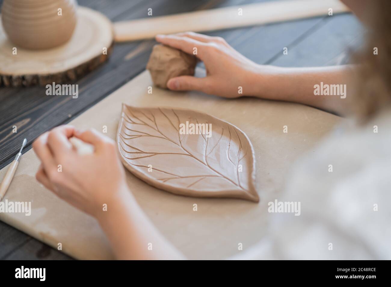 Woman decorating plate handmade hi-res stock photography and images - Alamy