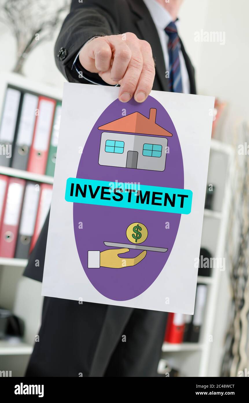 Paper showing investment concept held by a businessman Stock Photo - Alamy