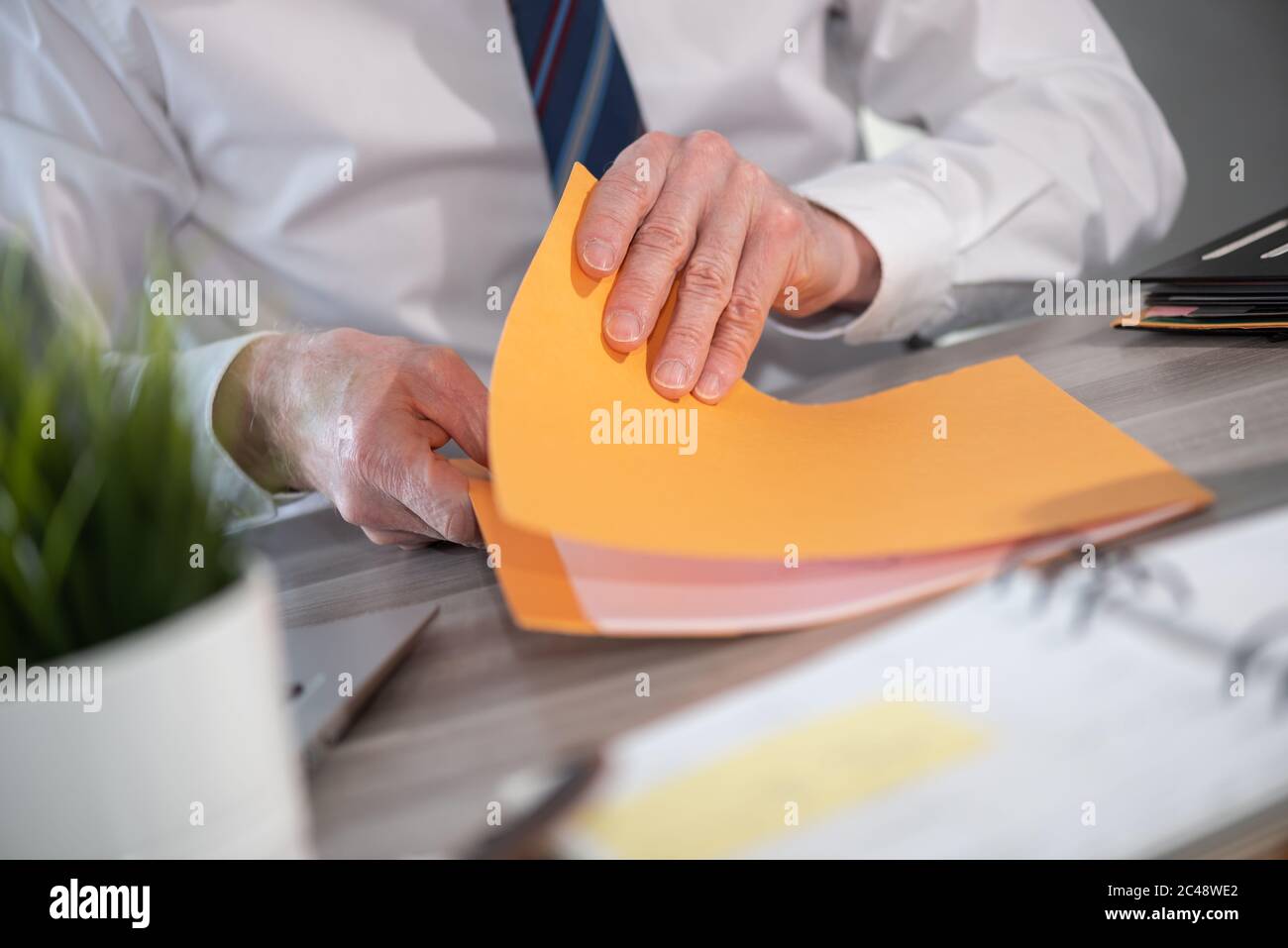 Businessman opening folder with paper documents Stock Photo - Alamy