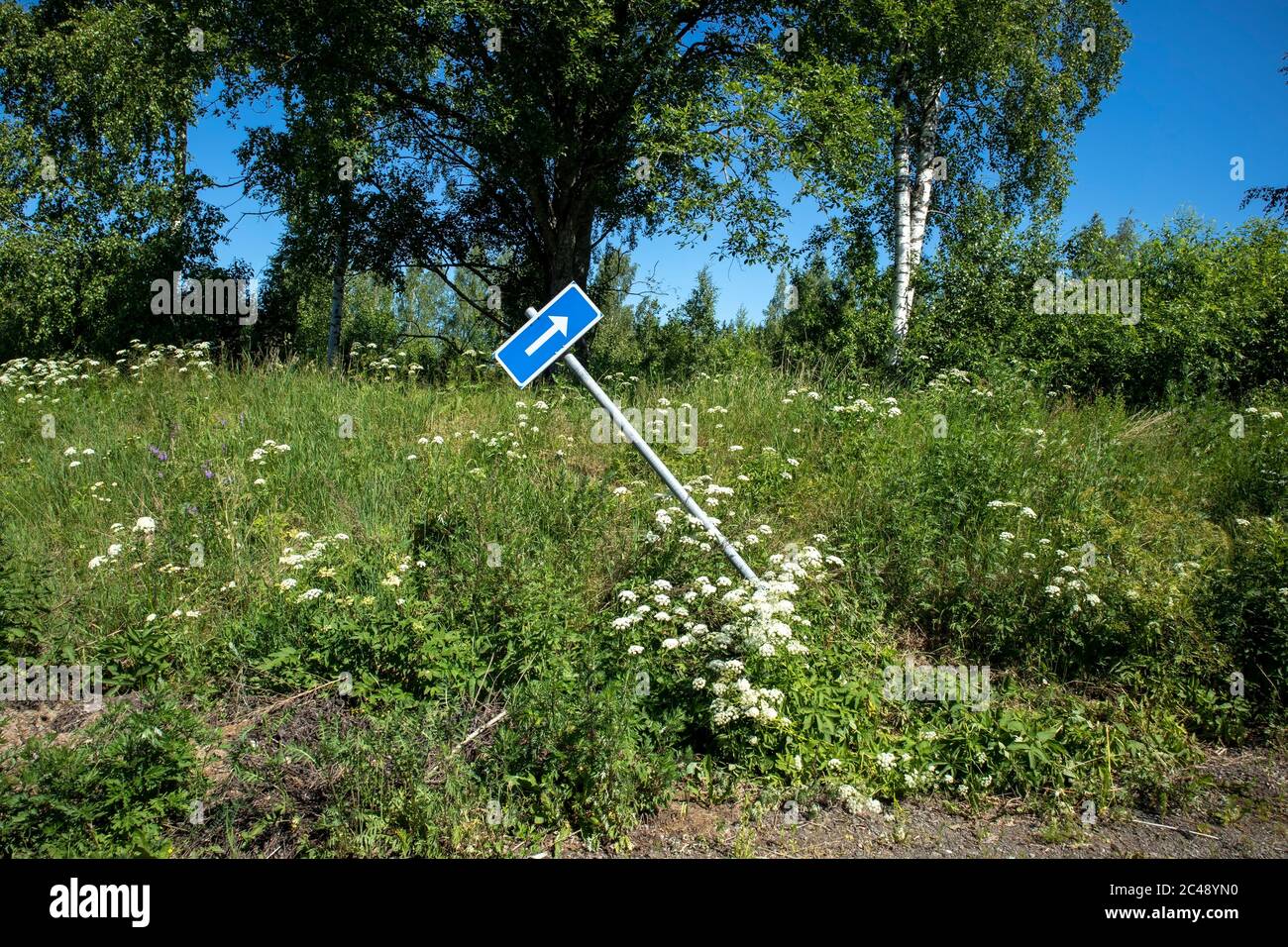 tilted traffic signpost with arrow pointing upper right Stock Photo - Alamy