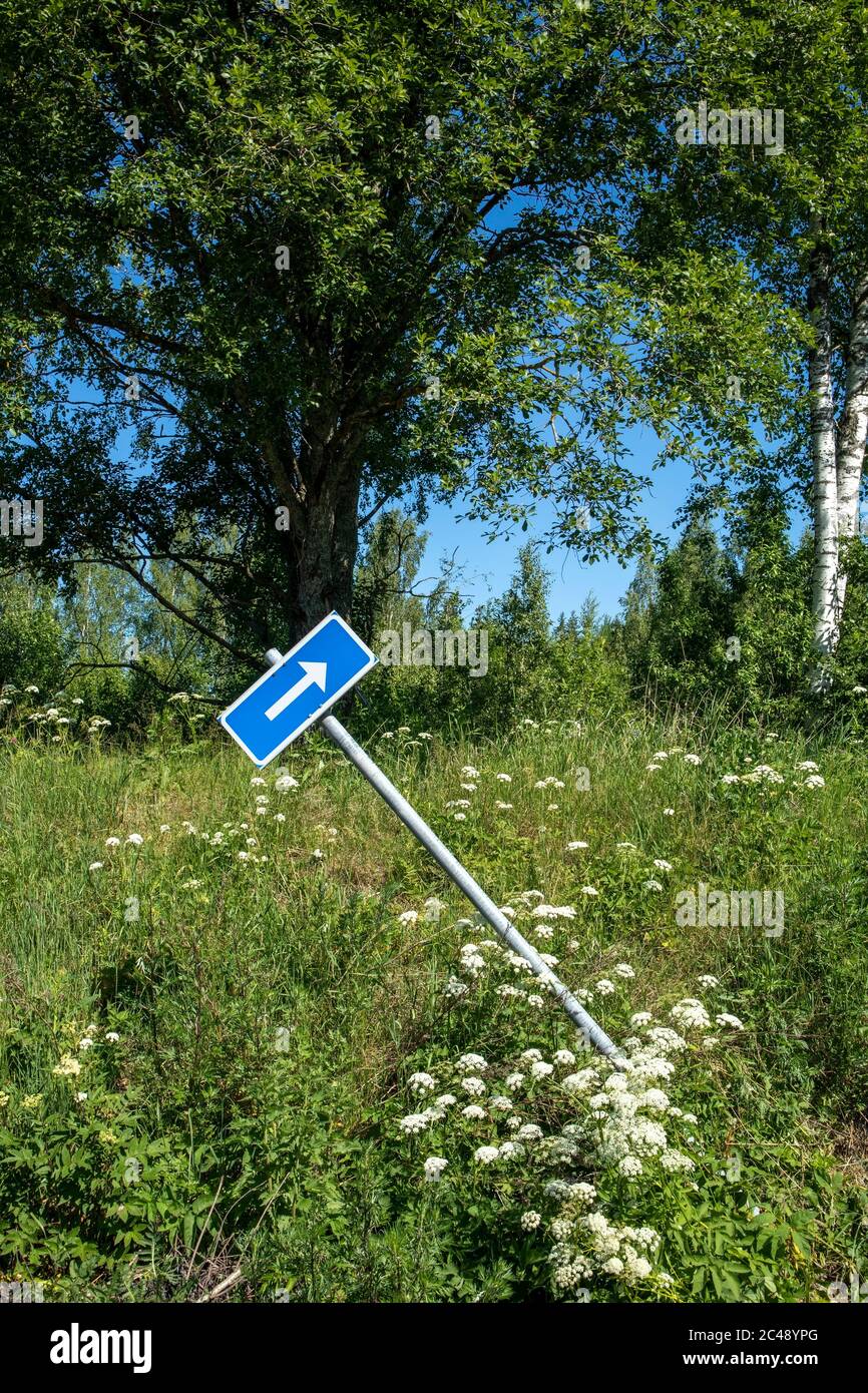 tilted traffic signpost with arrow pointing upper right Stock Photo - Alamy