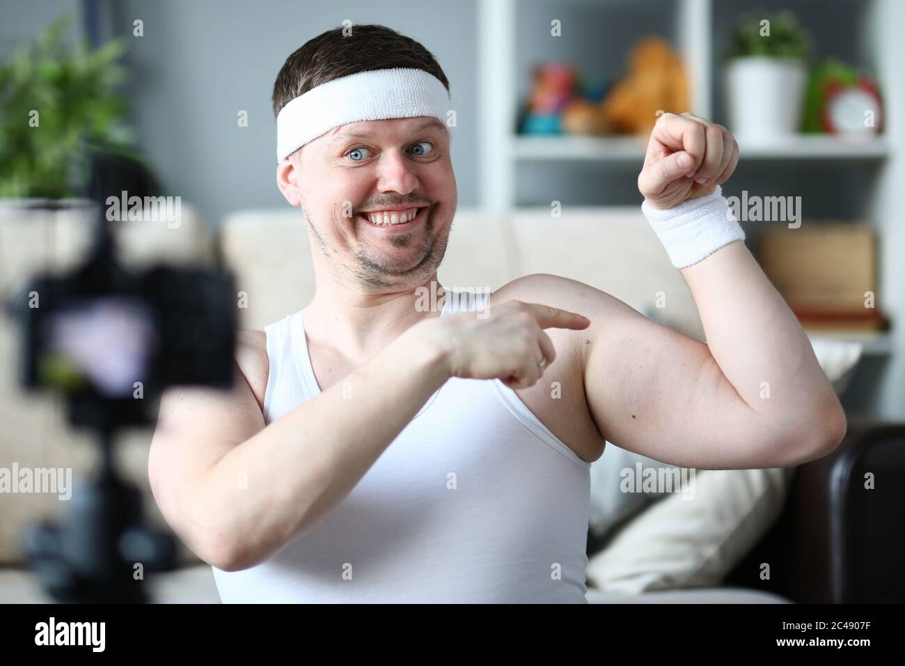 Young man point at biceps hi-res stock photography and images - Alamy