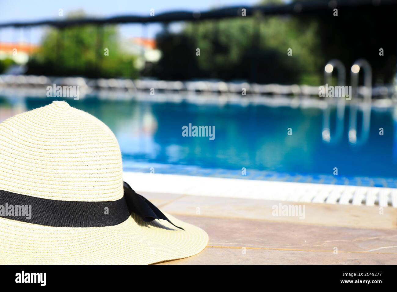sun hat, by the poolside, swimming pool luxury summer holiday concept ...