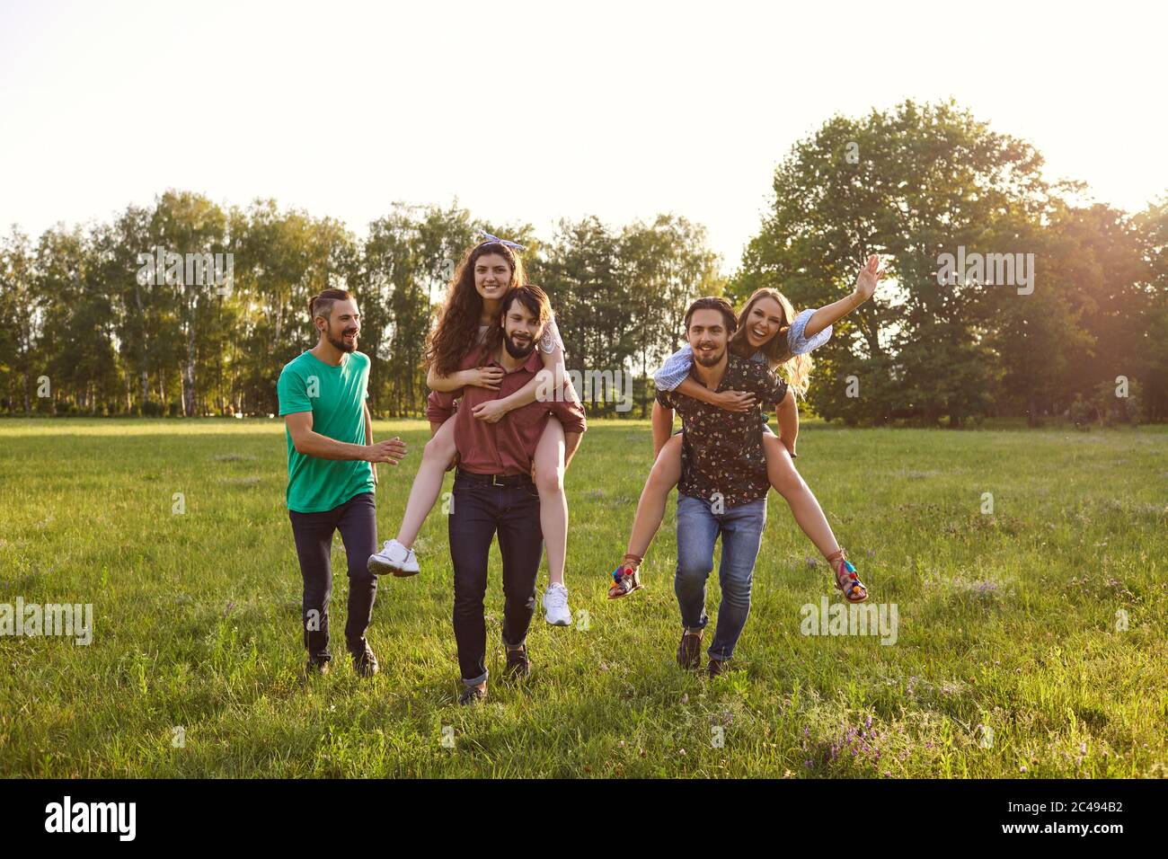 Young man giving girlfriend piggyback ride hi-res stock photography and ...