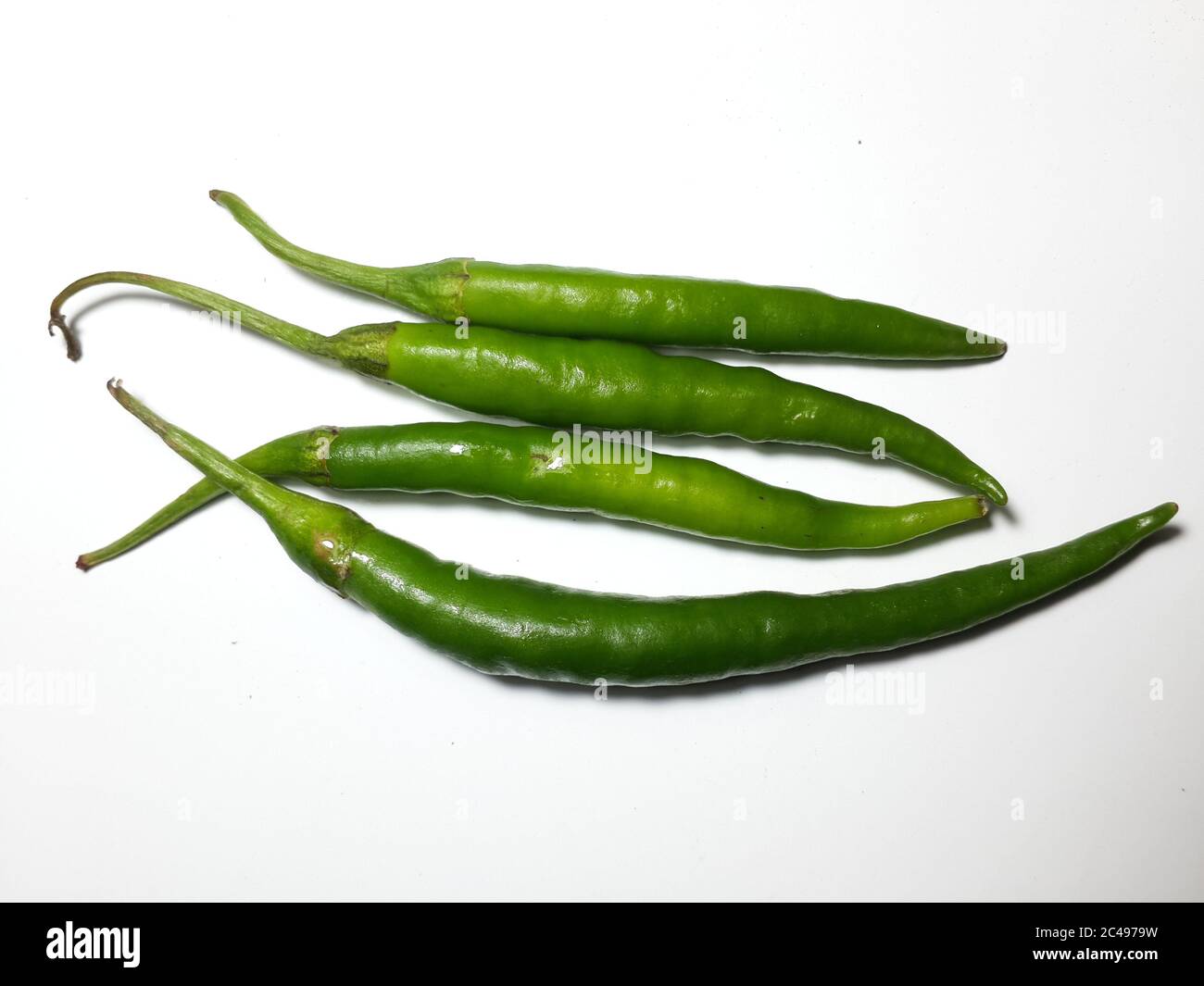Top view of four fresh long green jalapeno chili peppers isolated on ...
