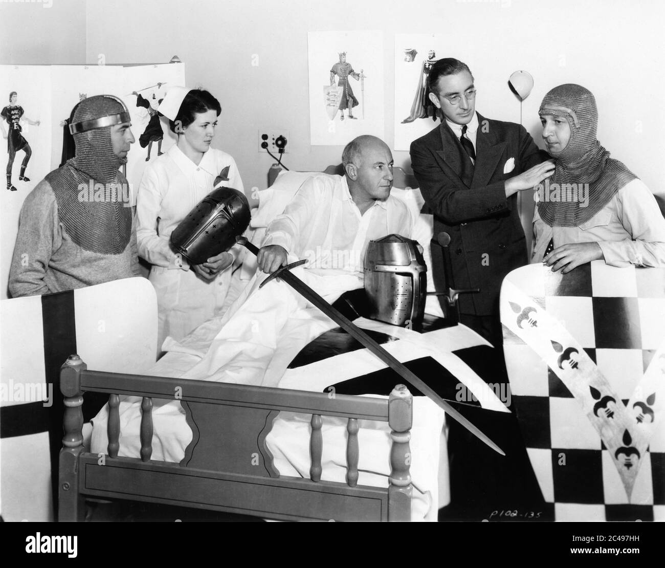 Director CECIL B. DeMILLE checks costumes with help of nurse and ...