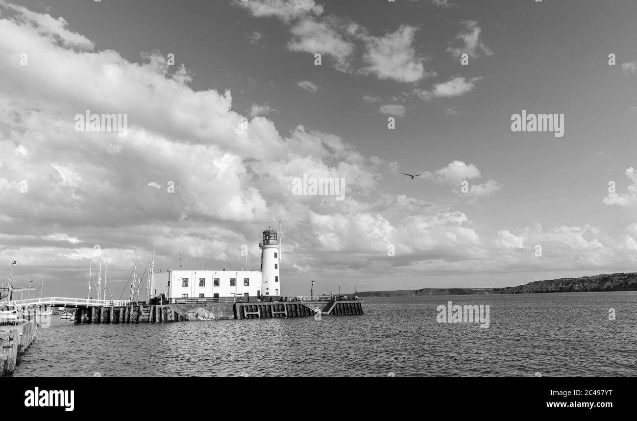 The lighthouse at Scarborough with a connecting bridge. There are ...