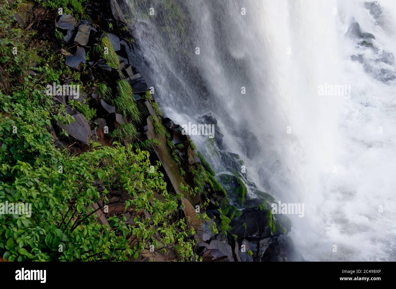 Water pouring over Devils Throat waterfall at Iguacu Falls, Brazil ...