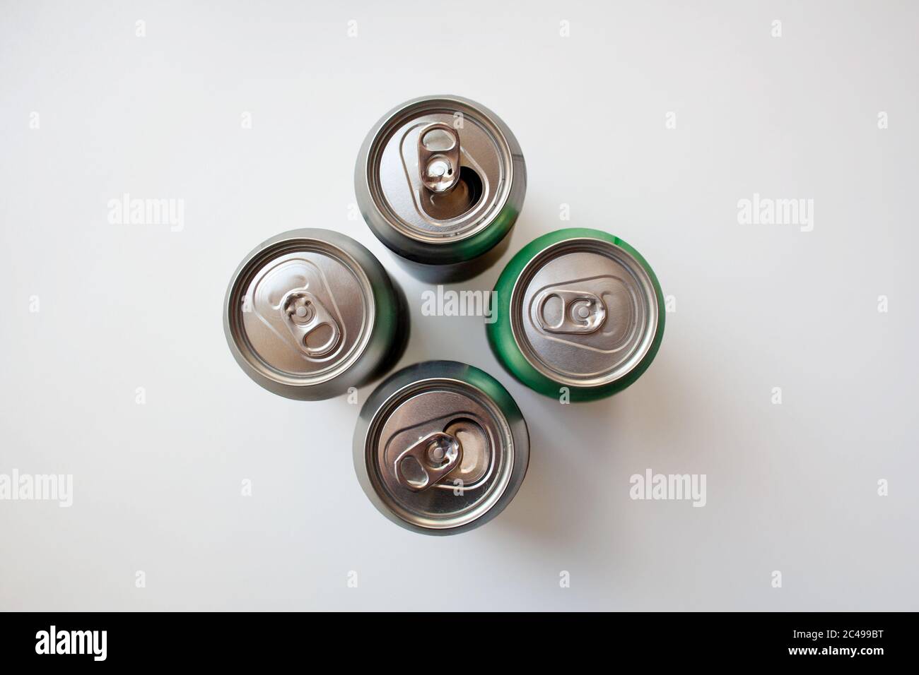 Four metal drink cans isolated on white background from a high angle ...