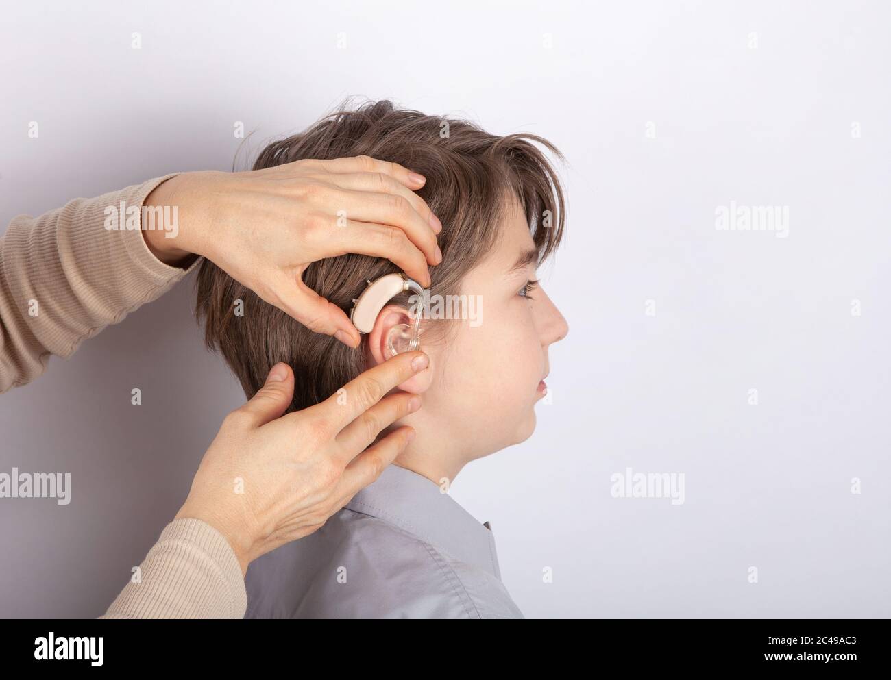 Deaf boy with hearing aid hi-res stock photography and images - Alamy