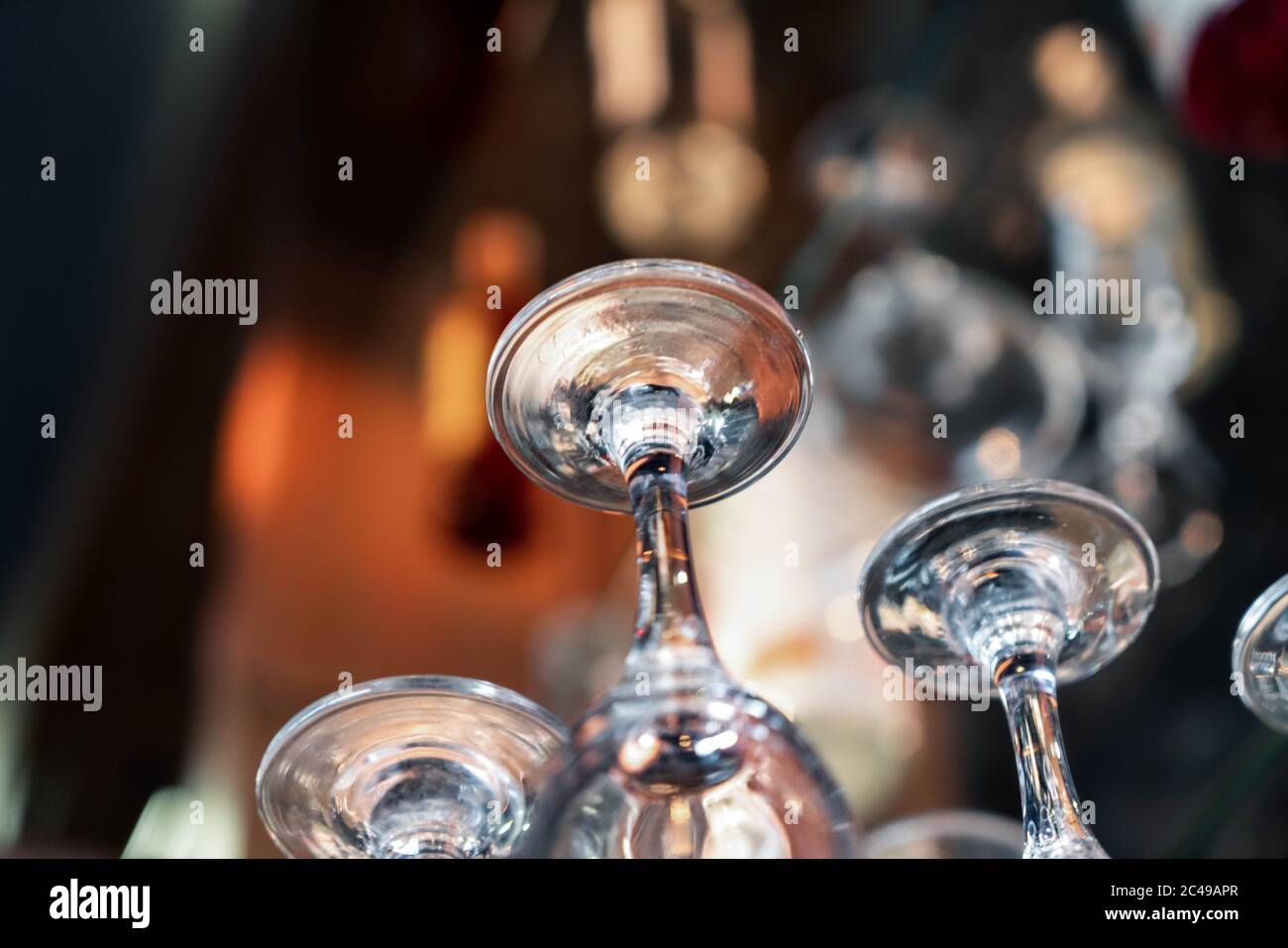 Close up inverted glass goblets in a bar. Inverted glasses and wine ...