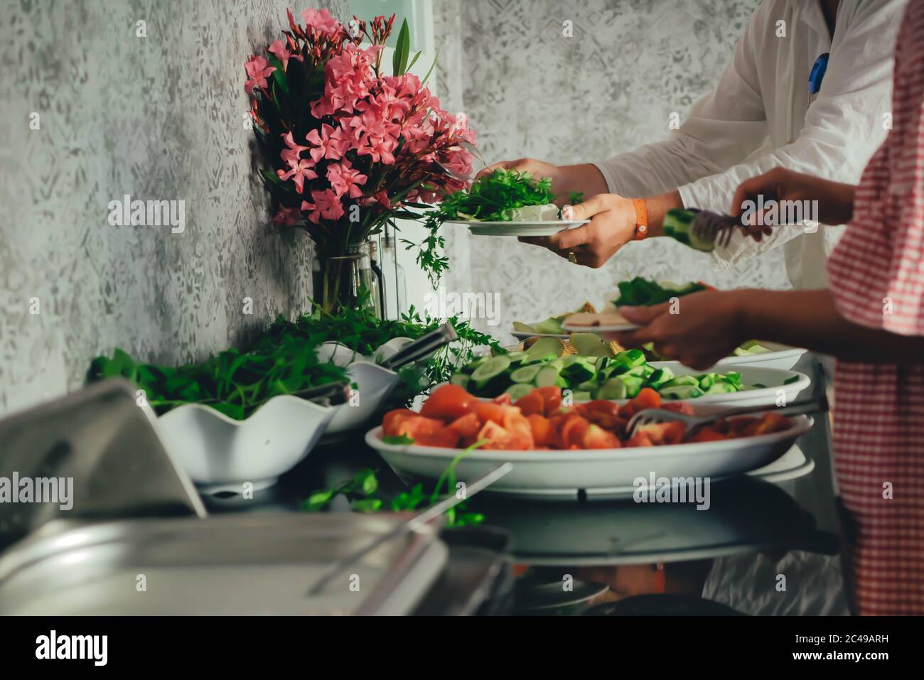 People or couple around table during brunch buffet with hands, putting ...