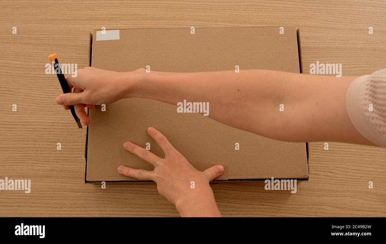 Unpacking a parcel of clothes Stock Photo - Alamy