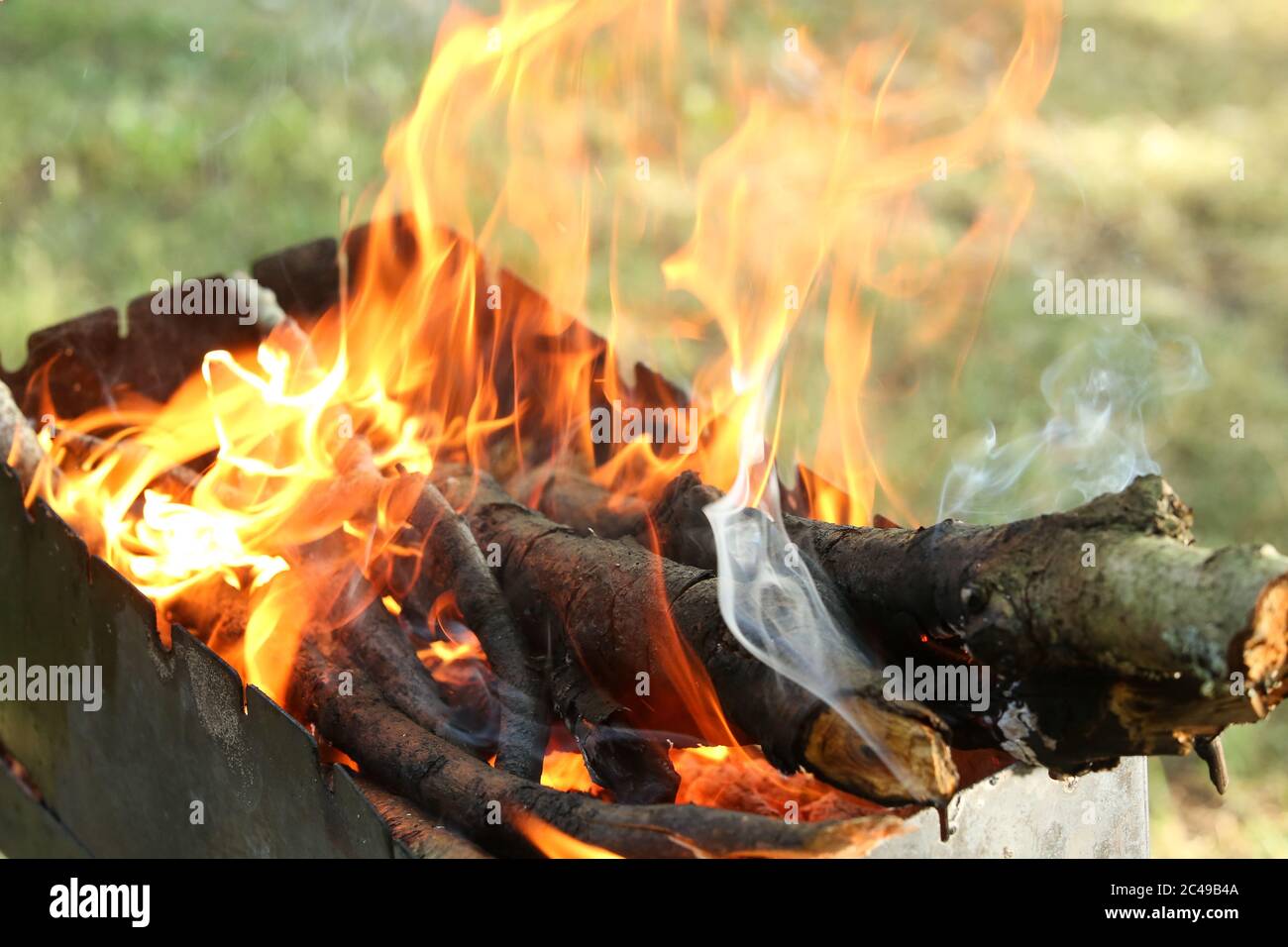 Fire with coals on a picnic . Preparing coals for cooking meat. Outdoor ...