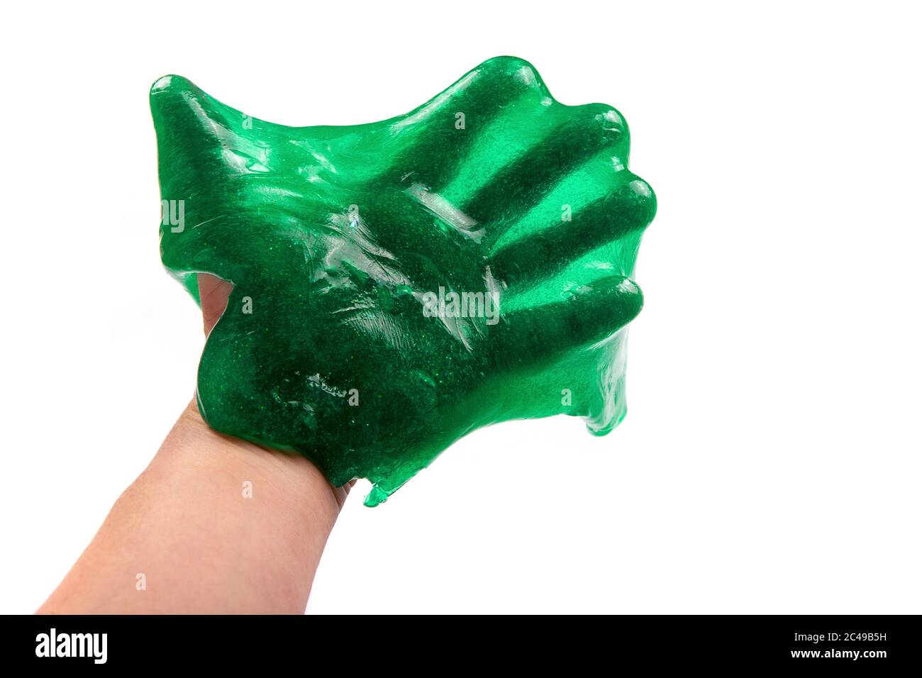 Hand holding a green slime isolated on white Stock Photo - Alamy