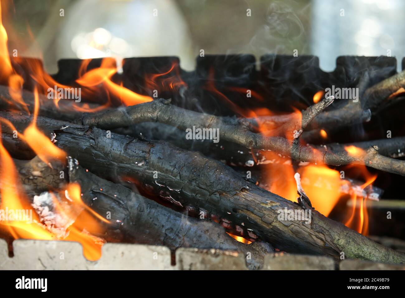 Fire with coals on a picnic . Preparing coals for cooking meat. Outdoor ...