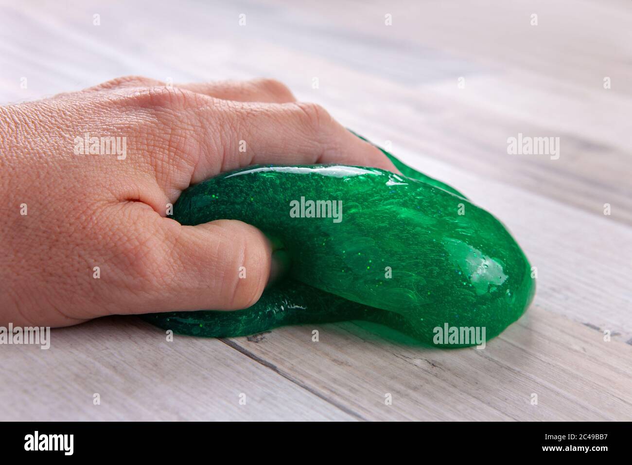 Hand with slime on a table Stock Photo - Alamy