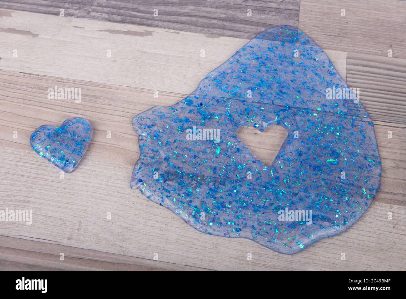 Glitter slime toy with a heart shape and its hole Stock Photo - Alamy