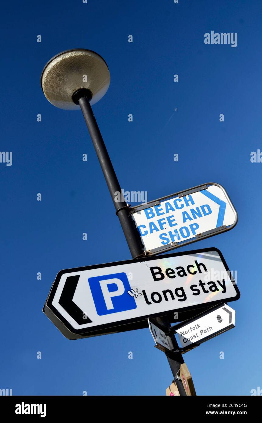 sign mundesley town prom with small airborne plane and con trail north ...