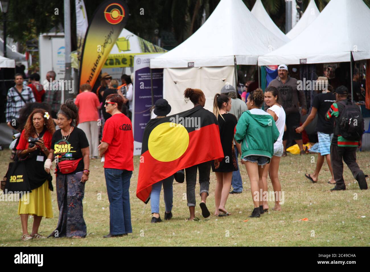 Girls carry the Aboriginal flag at the Yabun festival in Victoria Park ...