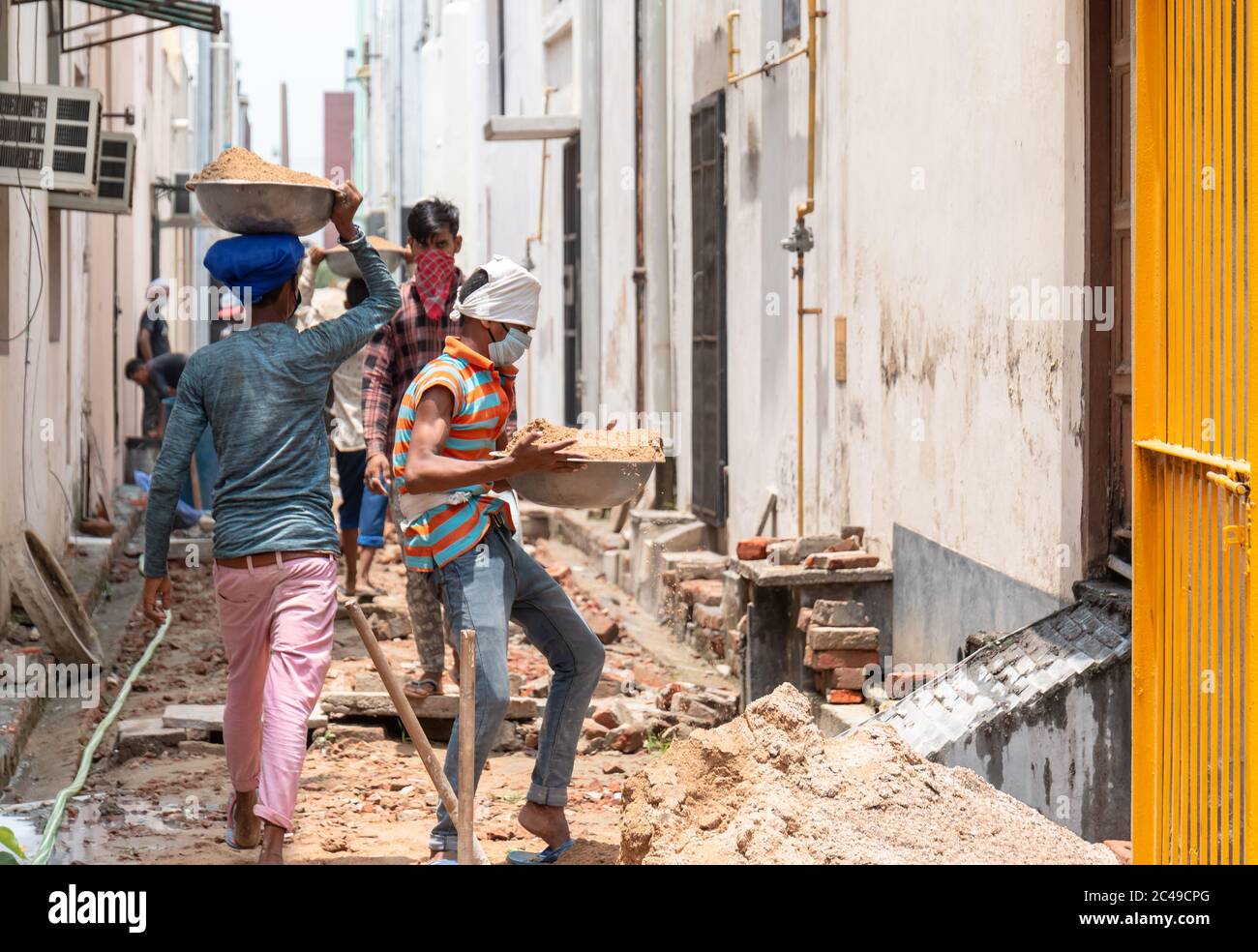 Young Indian male labor working at construction site with having ...