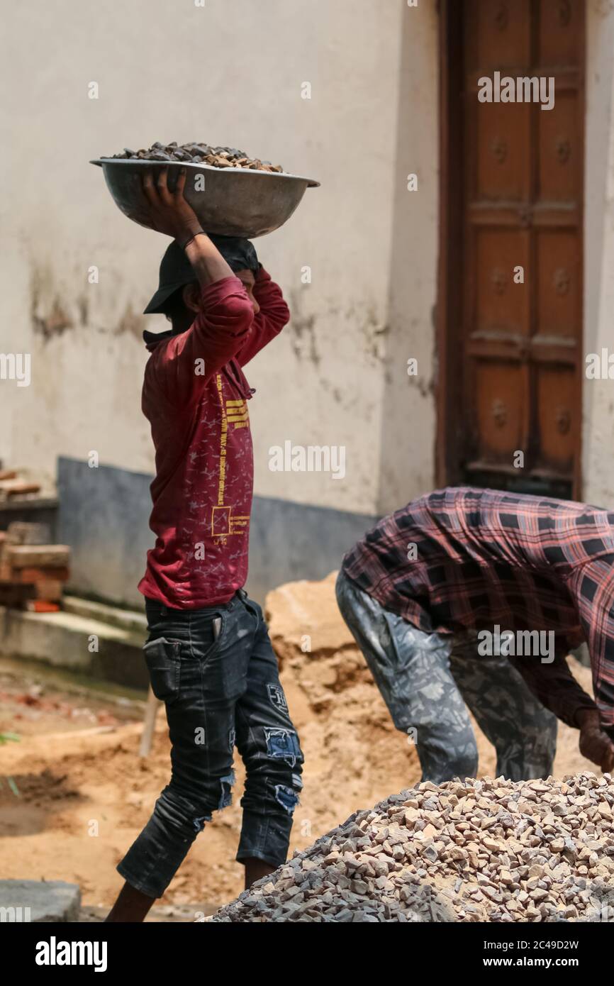 Young Indian male labor working at construction site with having ...