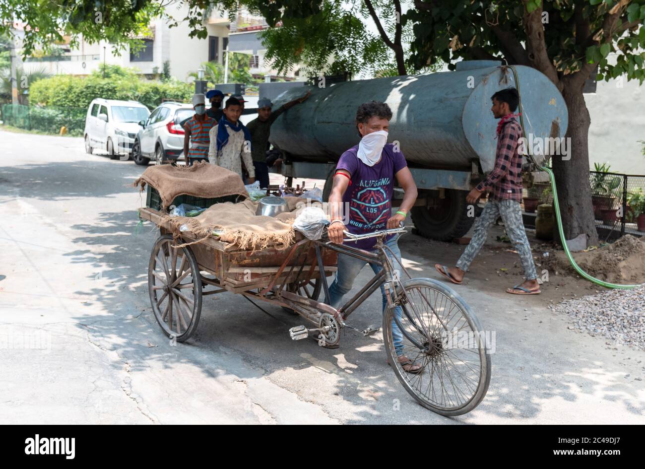 Young Indian male labor selling products on Cycle Rikshaw with Medical ...