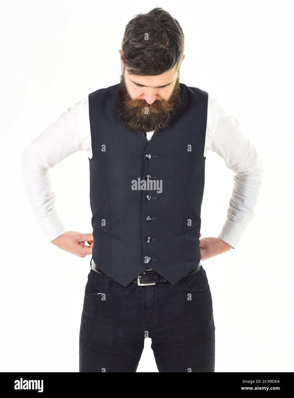 Sad bearded man with hands in pockets looking down. Full body length ...