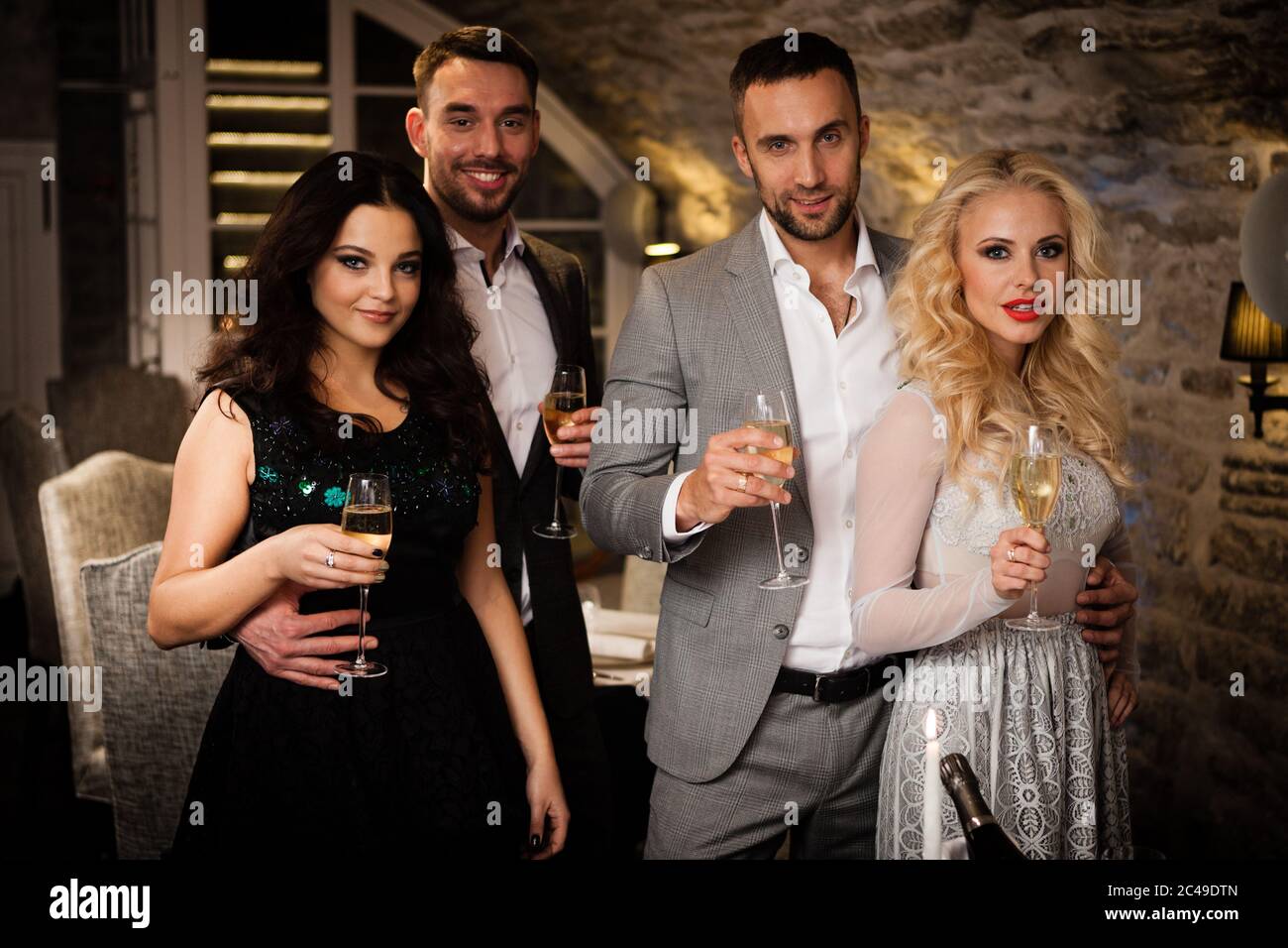 Party, holiday with friends concept. Four people with champagne glasses ...