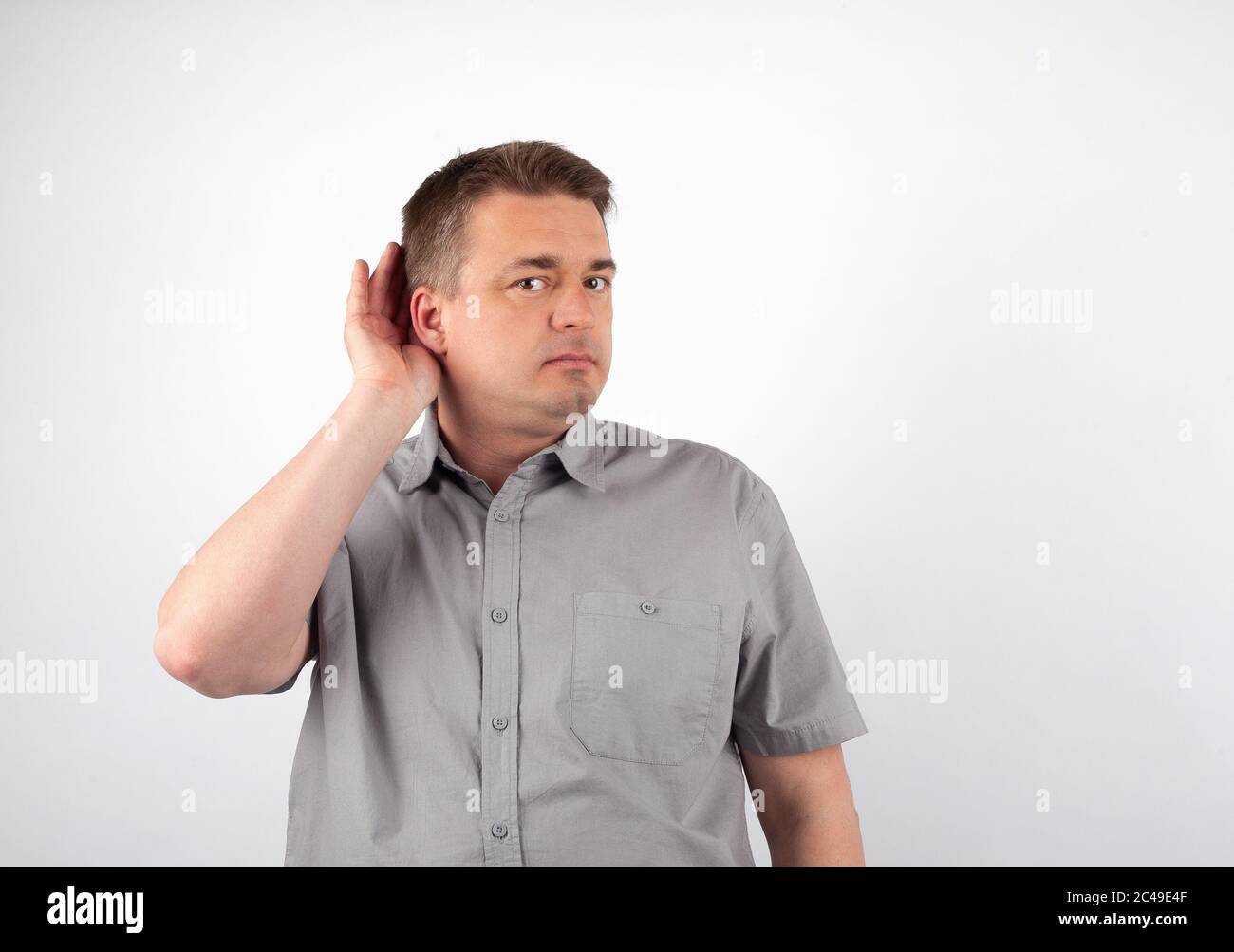 Man cupping ear hi-res stock photography and images - Alamy