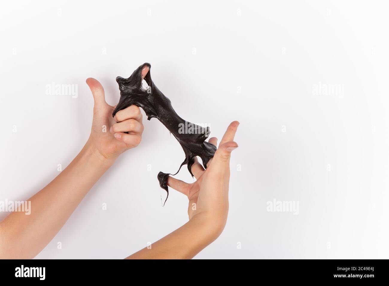 Hands with black slime Stock Photo - Alamy