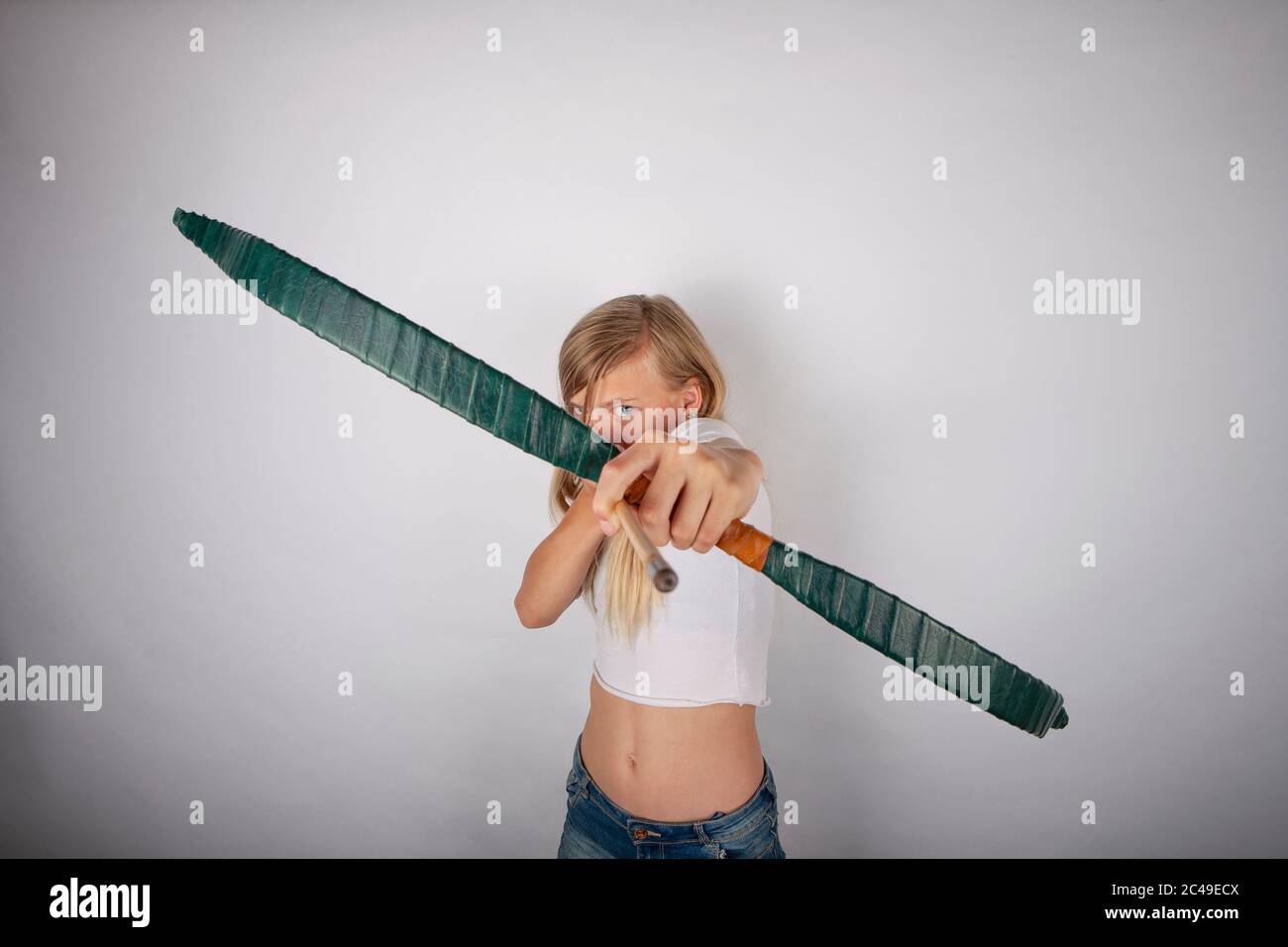 Young archer girl targeting on you with bow and arrow Stock Photo - Alamy