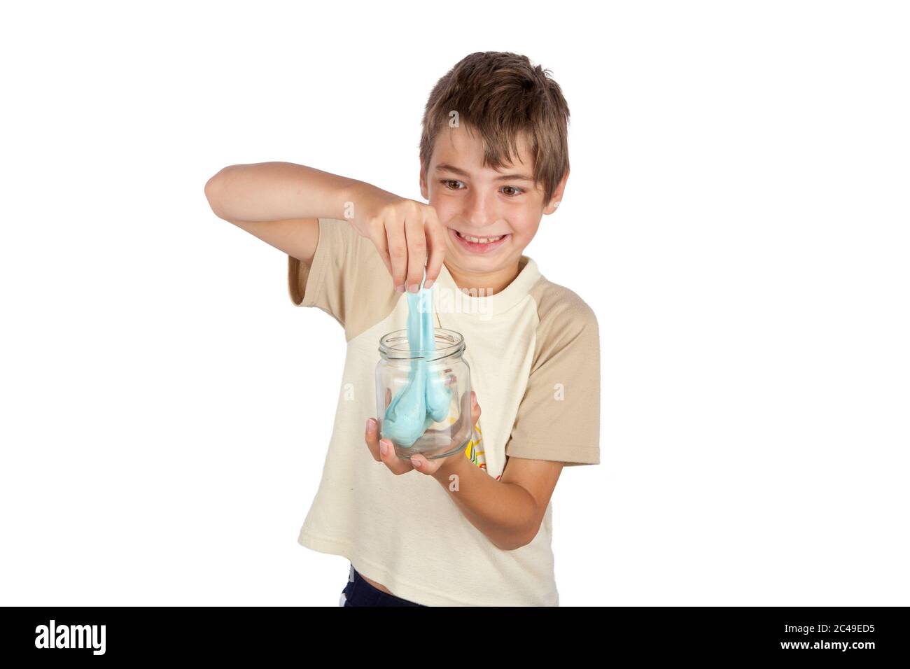 Young boy holding a jar and creating a home made slime toy. Isolated on ...
