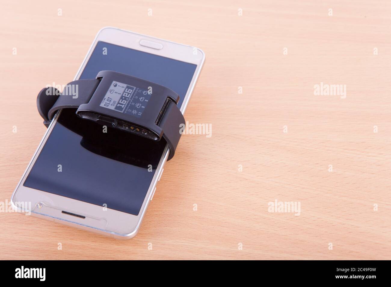 Smartphone and a smartwatch on an office table Stock Photo - Alamy