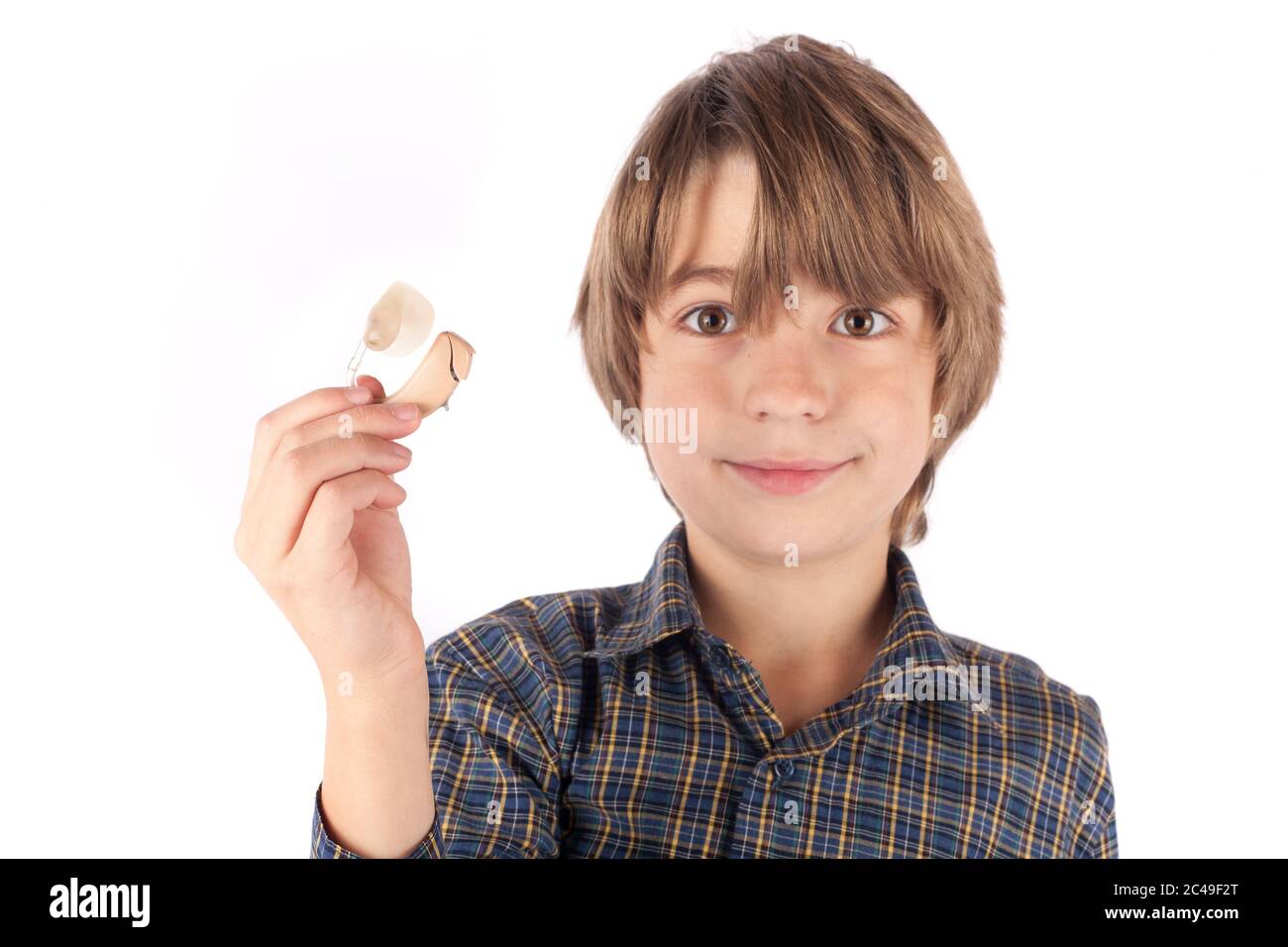 Cute boy showing a hearing aid. Isolated on white background Stock ...