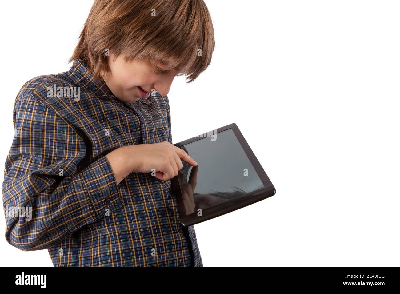 Boy touching his tablet device screen. Isolated on white background ...