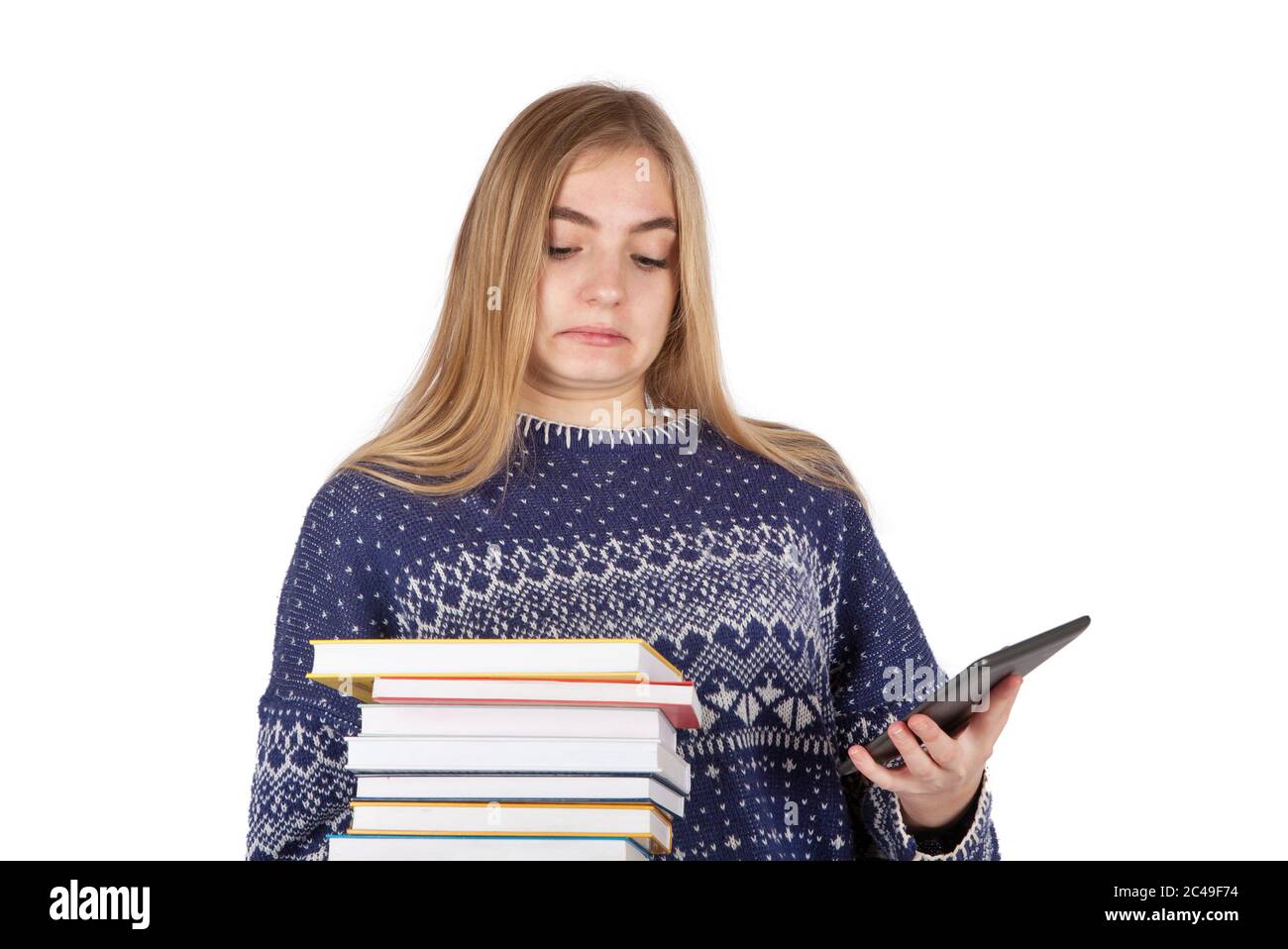 School girl trying to decide between books and an ebook reader ...