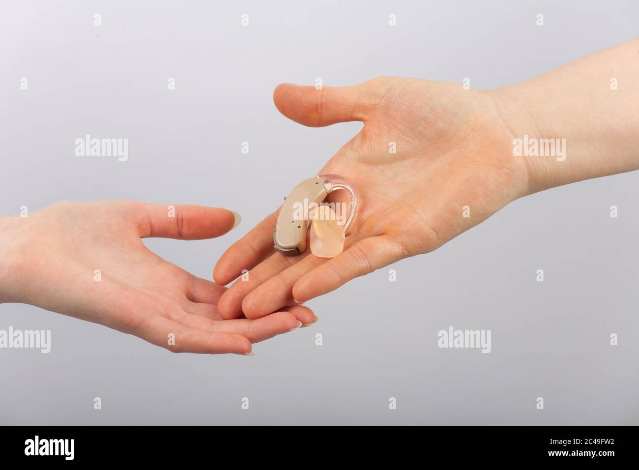 Doctor giving hearing aids hi-res stock photography and images - Alamy